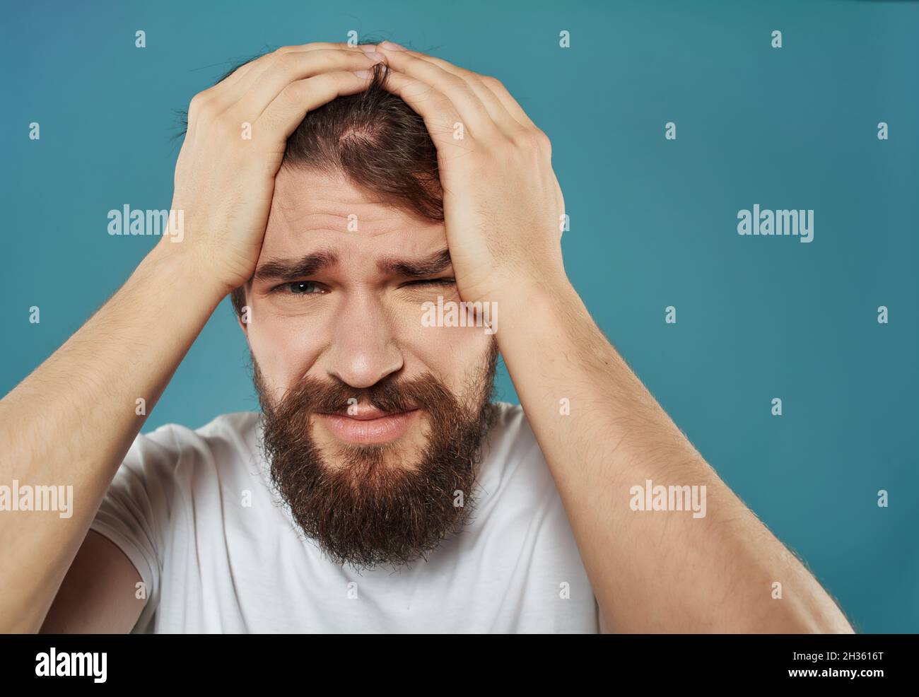 Man in a white t-shirt irritated facial expression Studio Stock Photo ...