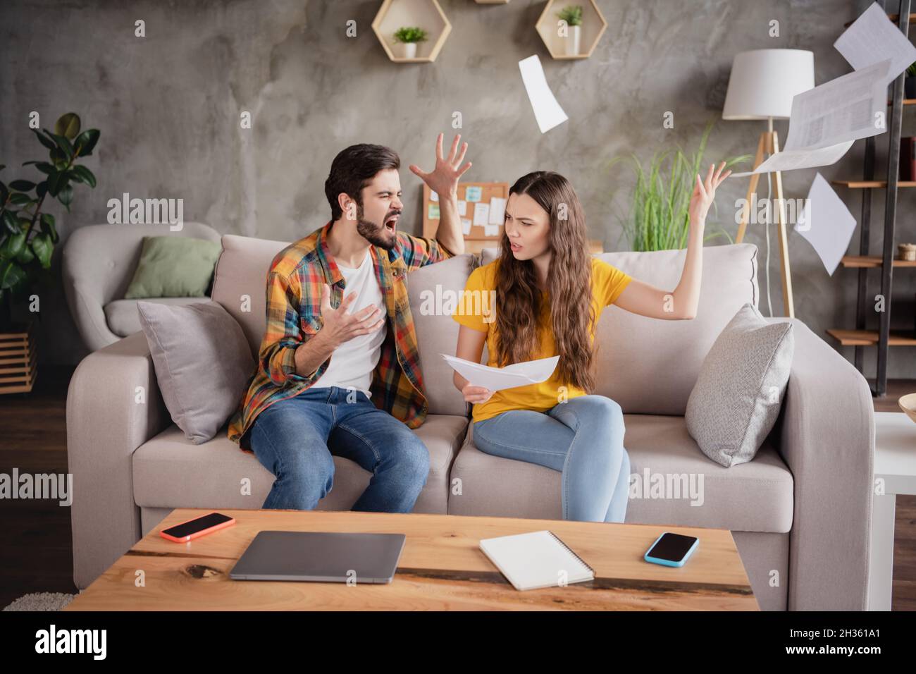 Photo of annoyed angry young couple wear casual outfits busy working ...