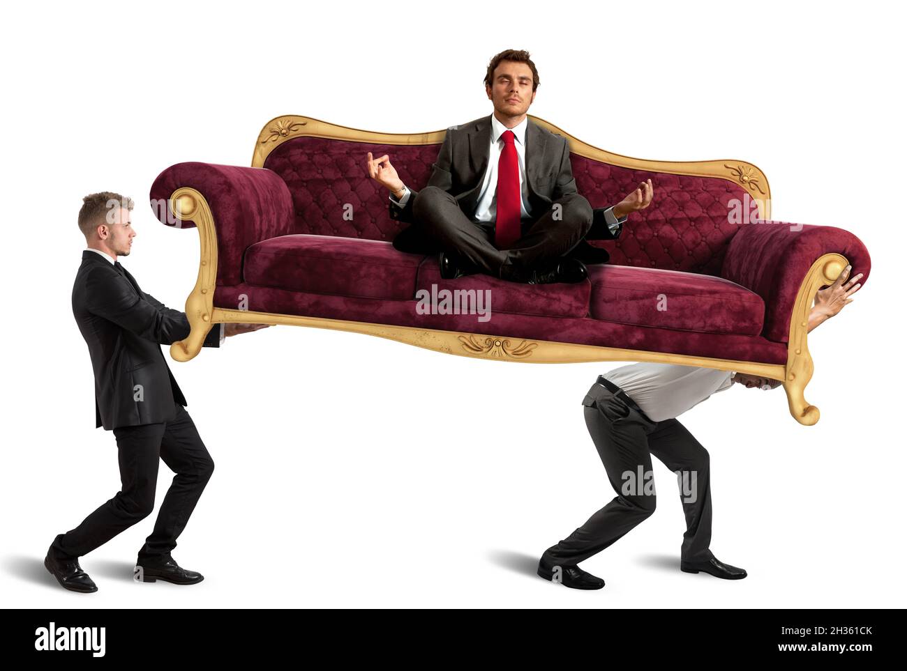 Employees carrying boss doing yoga on sofa Stock Photo - Alamy