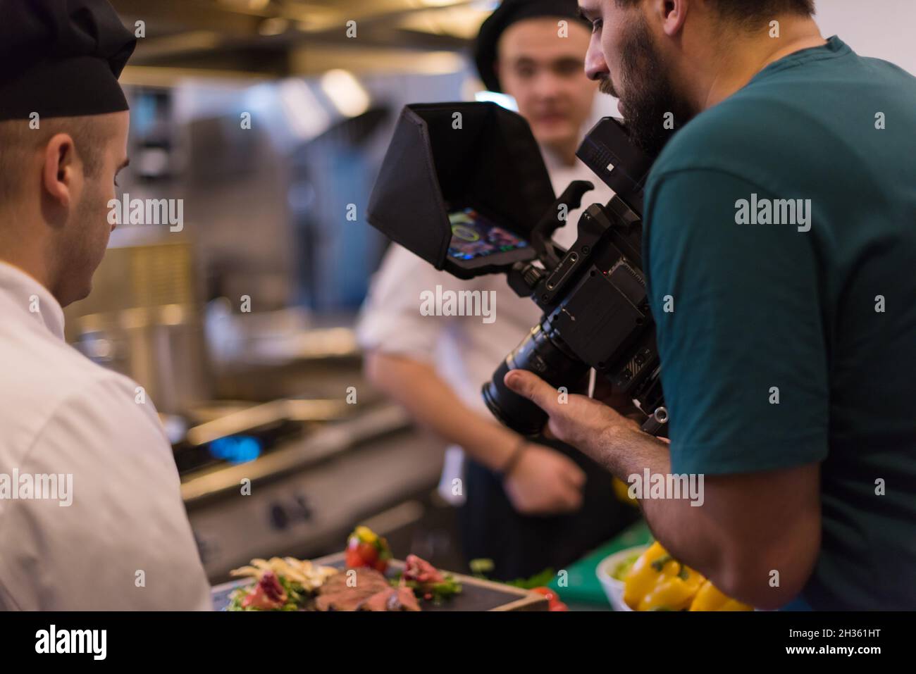 videographer recording while Professional team cooks and chefs ...