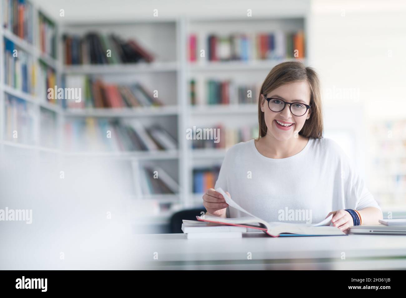 female student study in school library, using laptop and searching for ...