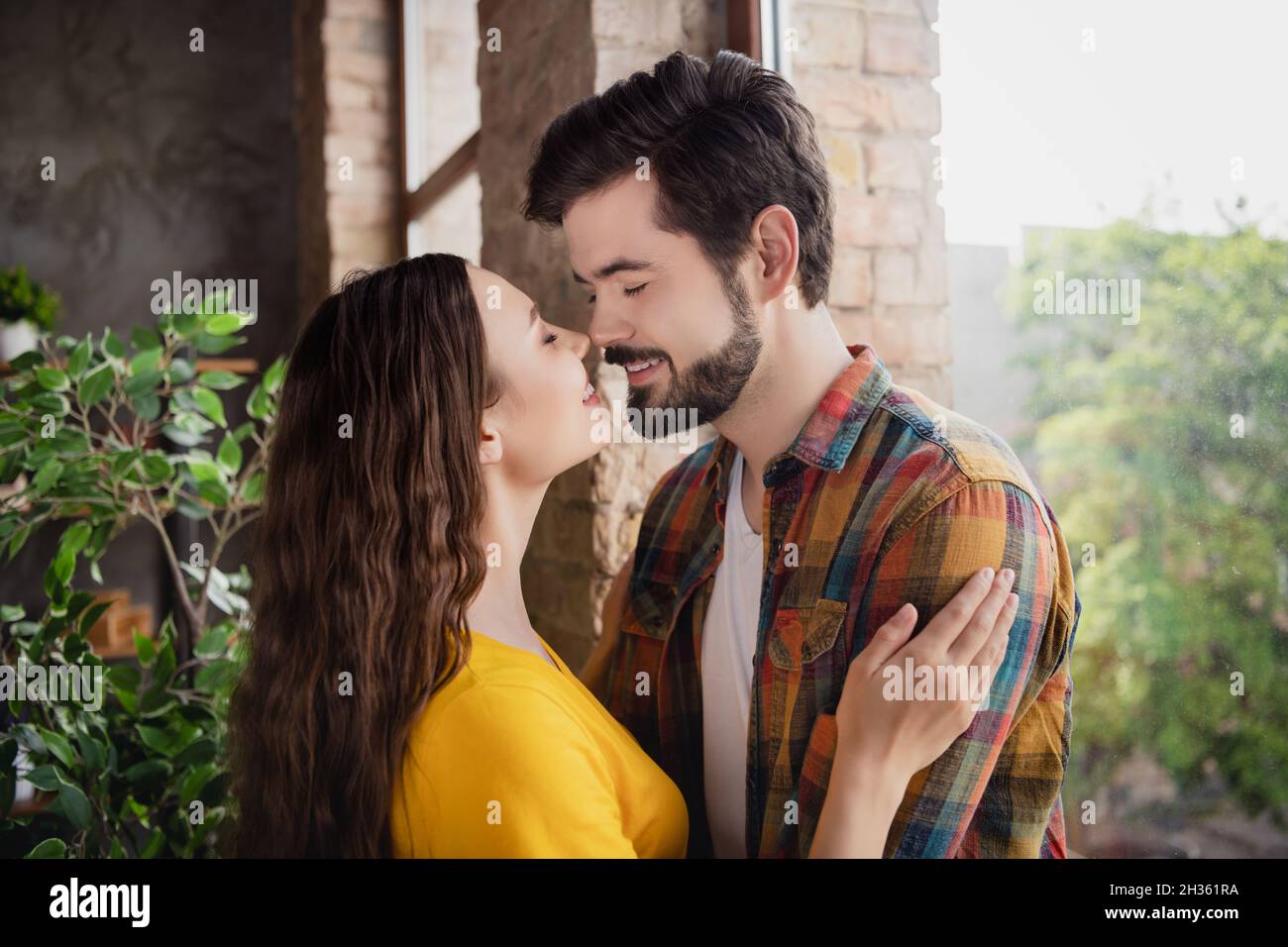 Photo of tender tempting adorable couple cuddle enjoy kiss close eyes ...