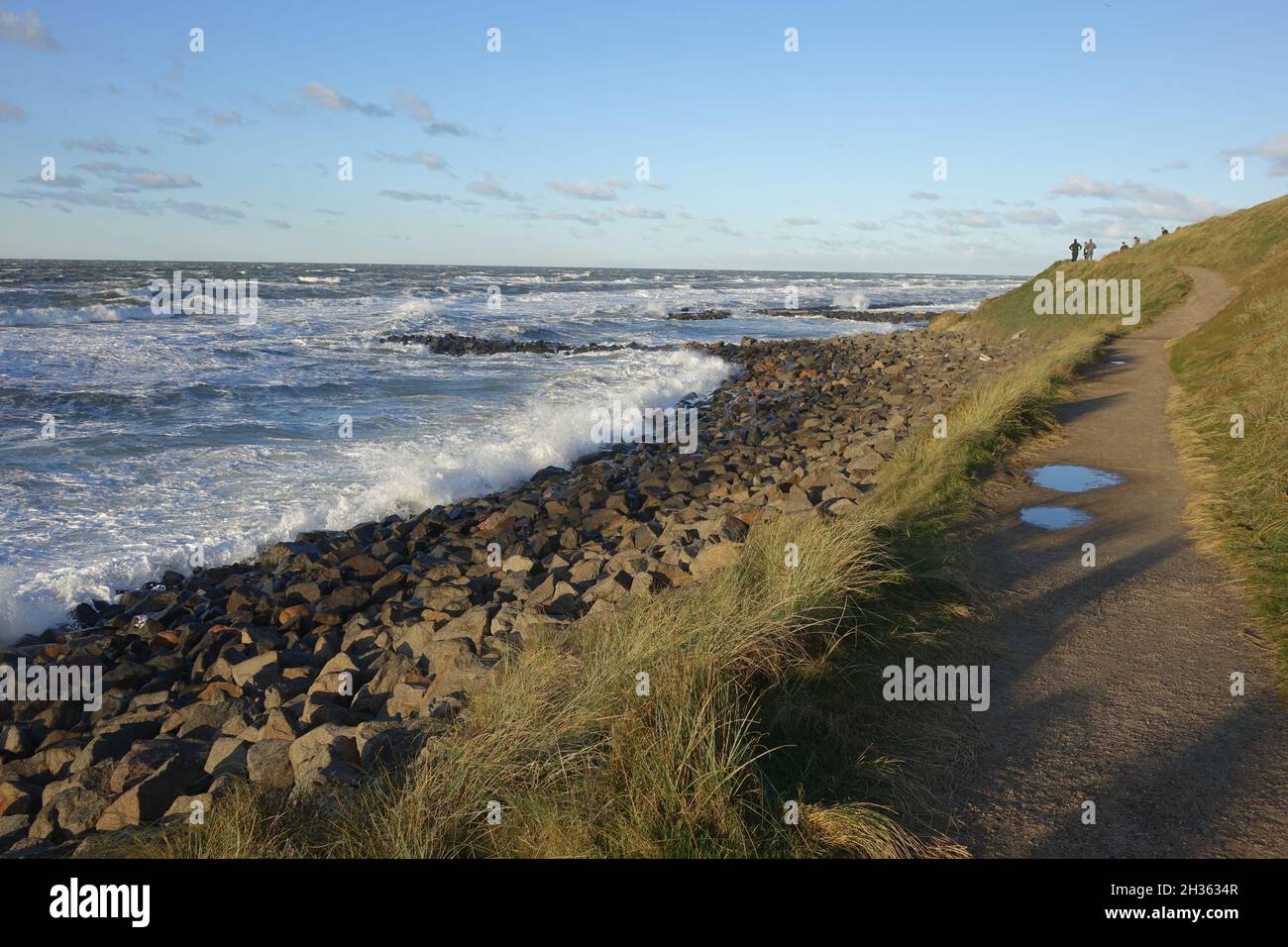 Hiking the coastal path of Lonstrup on a sunny and stormy day ...