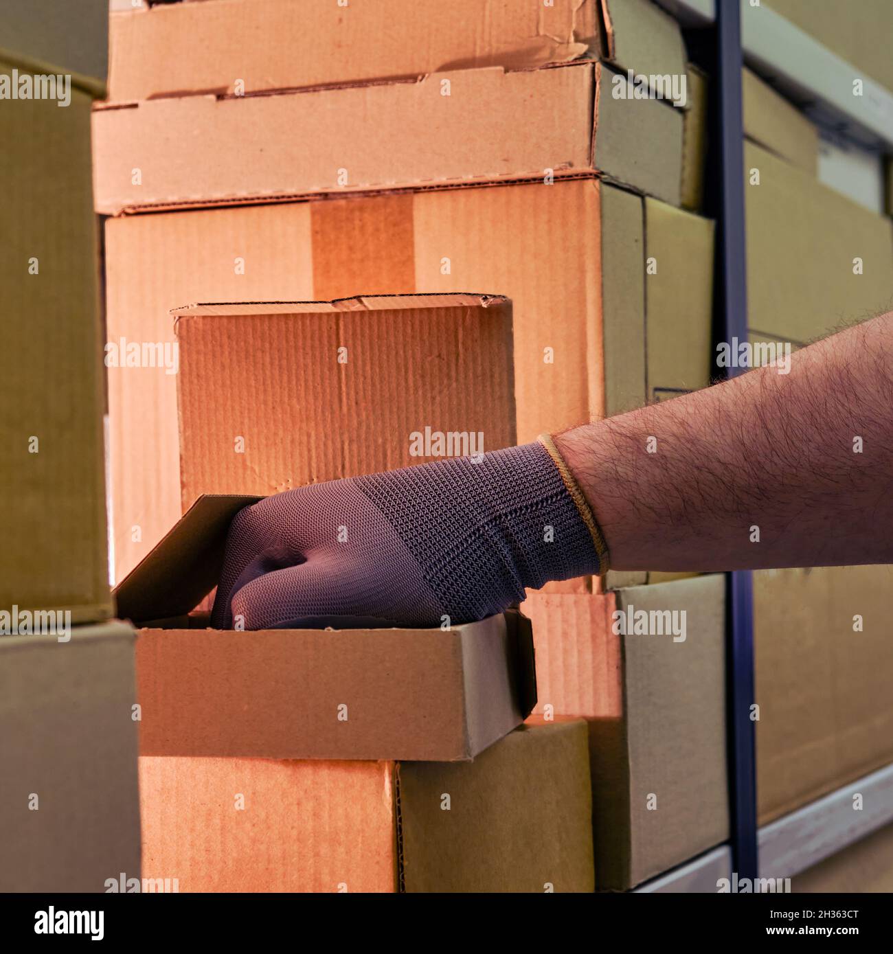 Theft from a box in a warehouse when sending goods by mail, hand in ...