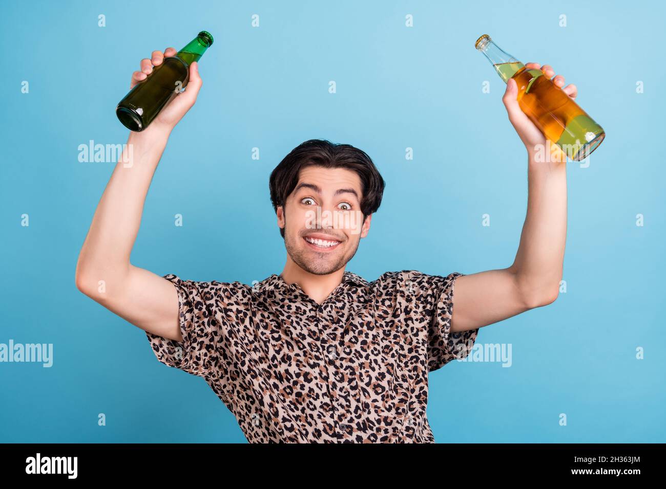 Portrait of attractive cheerful guy drinking beer celebrating good mood ...