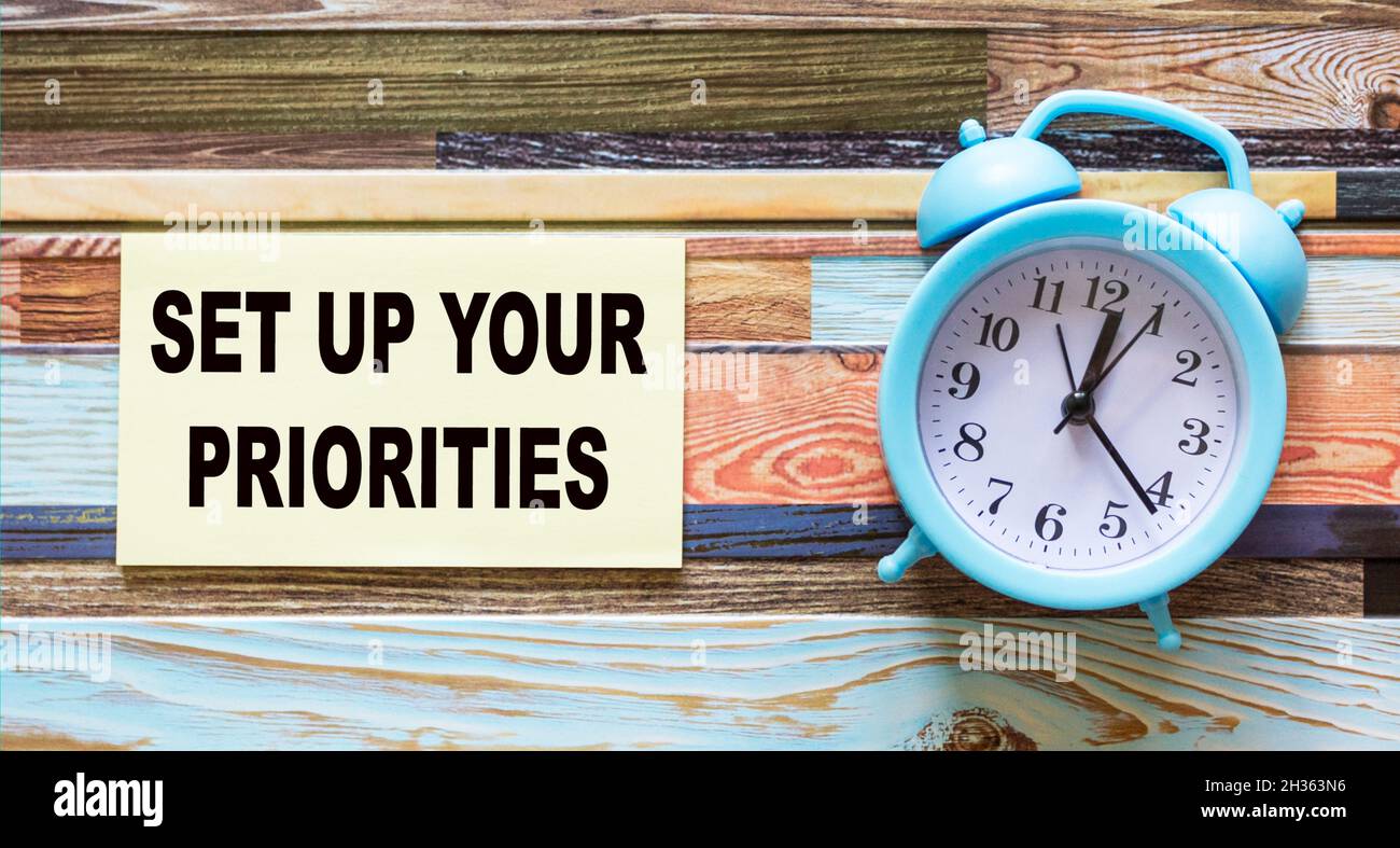 White notepad with text Set up your priorities , color background with ...