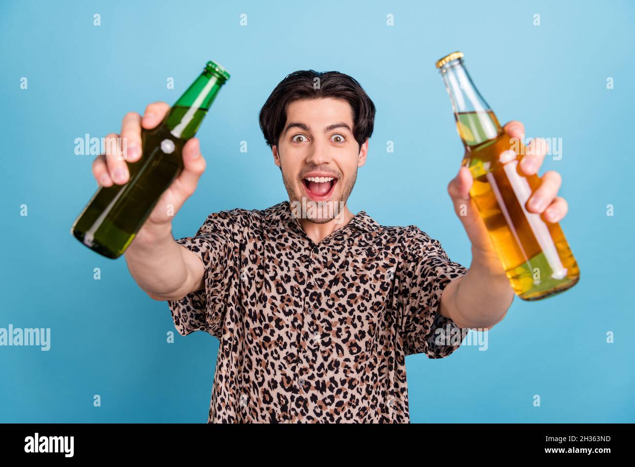 Portrait of attractive cheerful guy drinking cider celebrating having ...
