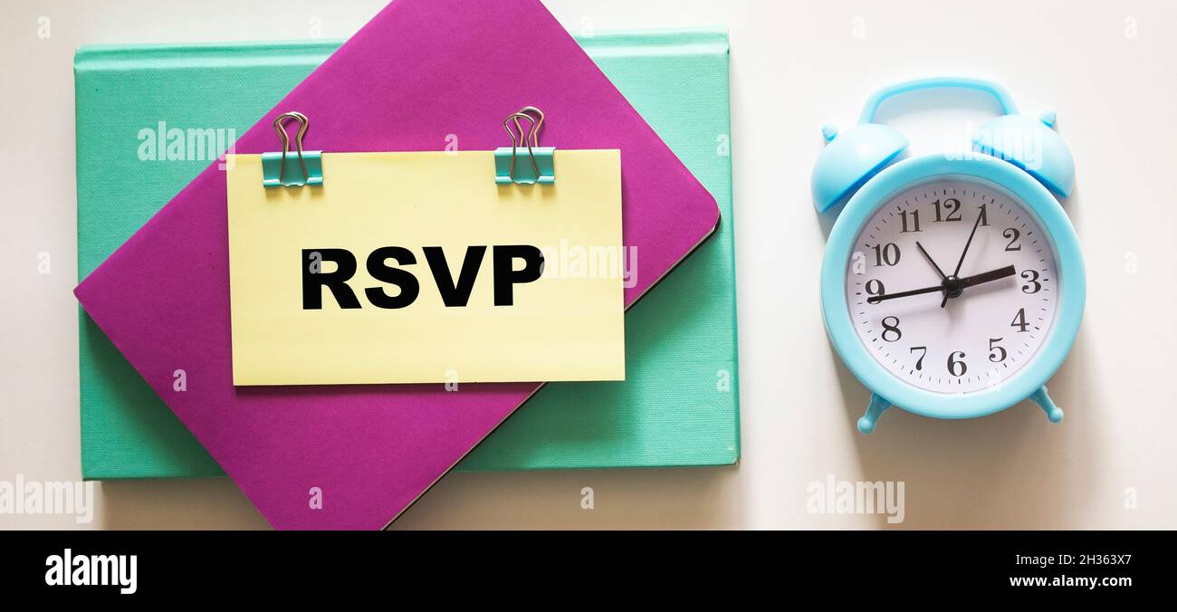 Sticker with RSVP text on colored notebooks and white background, near ...