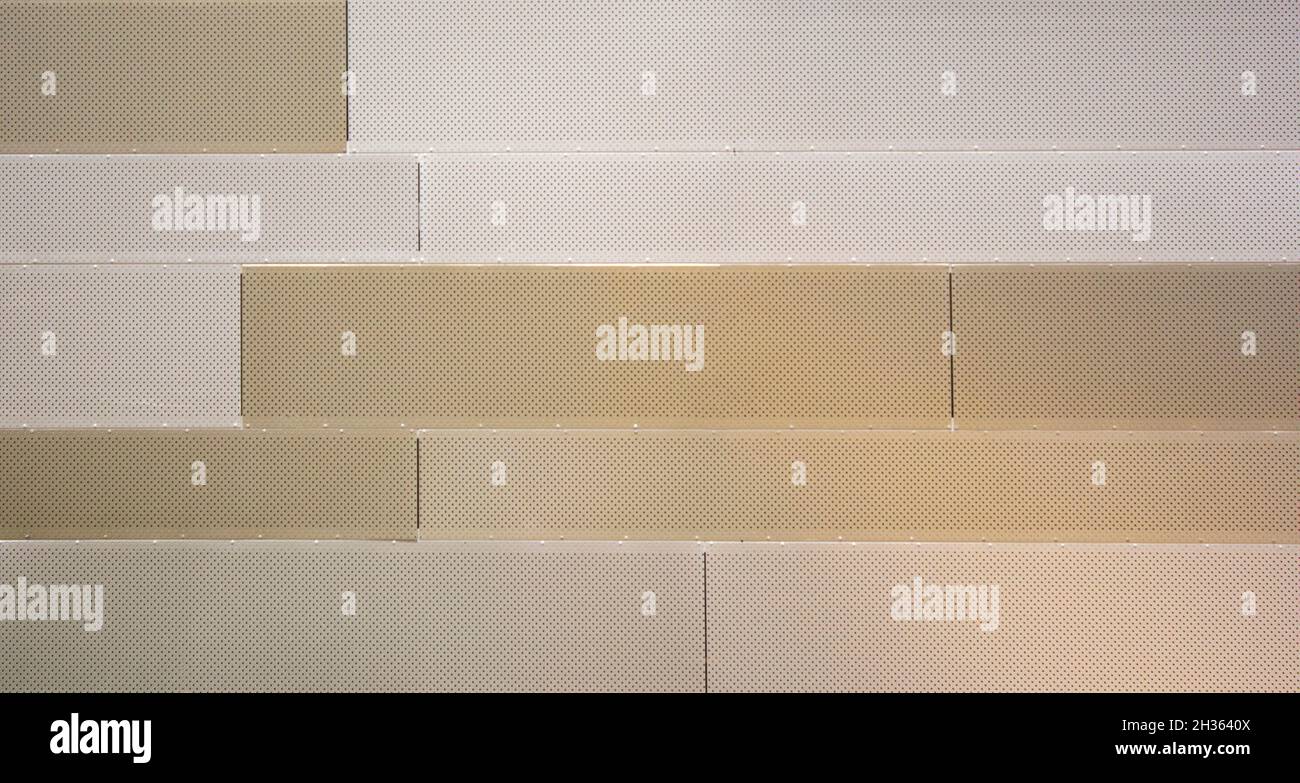 Beige metal wall made of blocks with small holes Stock Photo - Alamy
