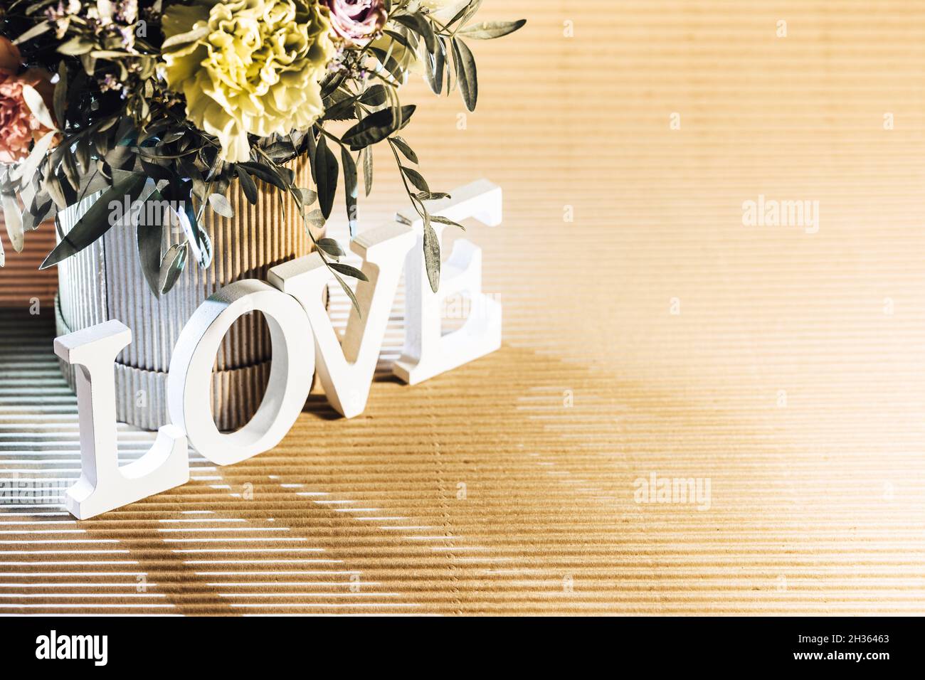 Eco friendly composition with white letters LOVE and flowers bouquet in ...