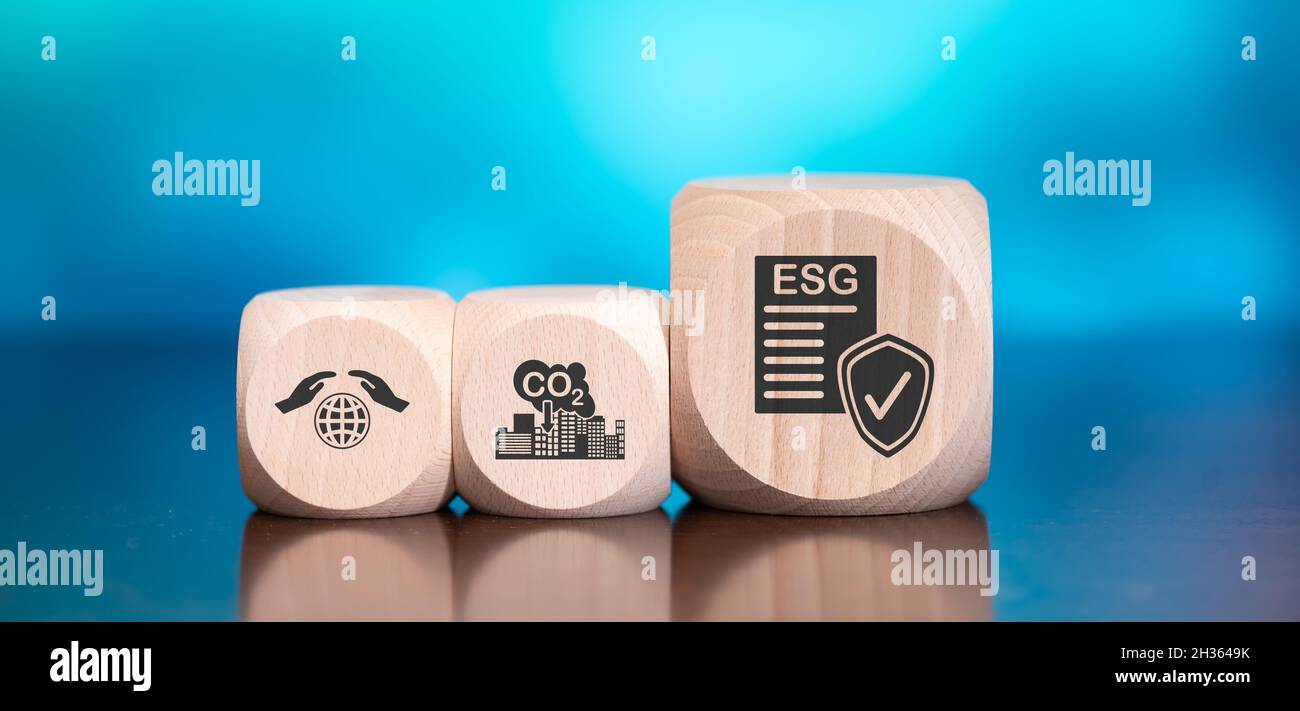 Wooden blocks with symbol of esg concept on blue background Stock Photo ...