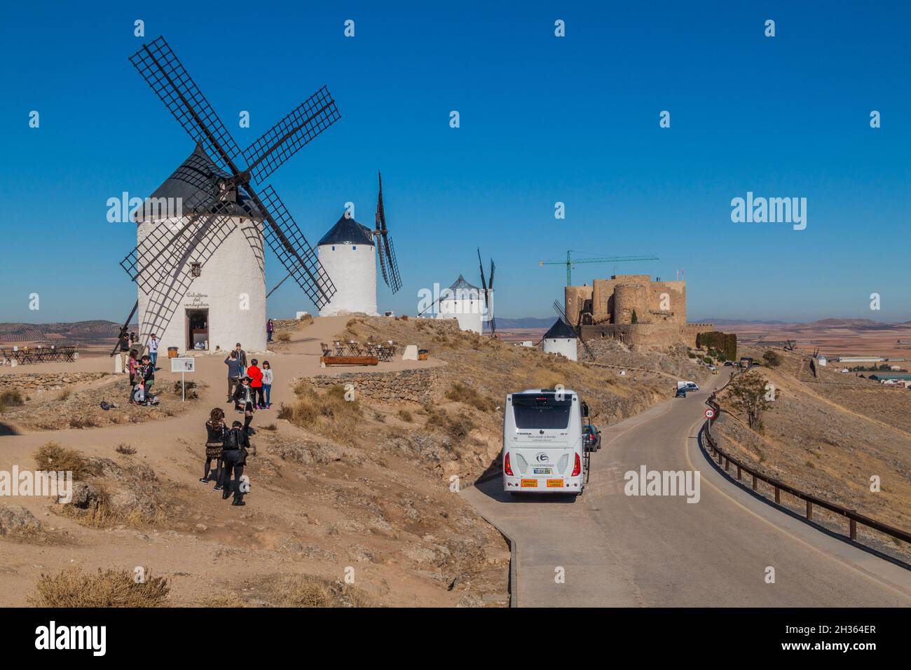 CONSUEGRA, SPAIN - OCTOBER 24, 2017: Windmills and a castle above ...