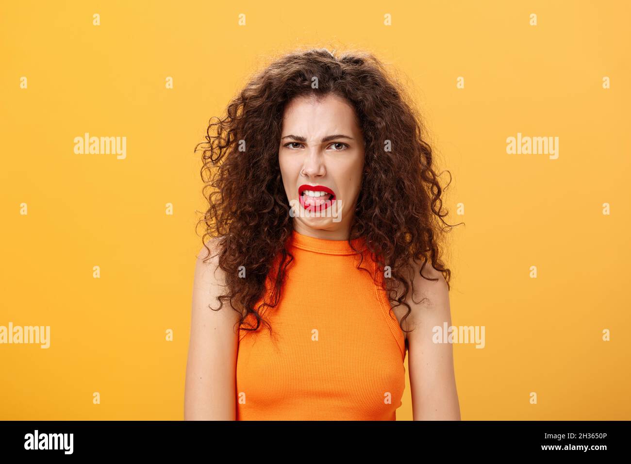 Girl being disgusted with row food sticking out tongue and frowning ...