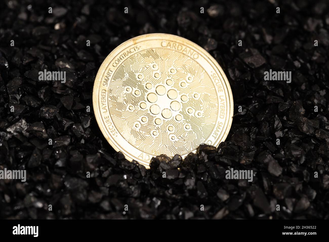 Cardano coin on black gravel background. Cryptocurrency blockchain ...