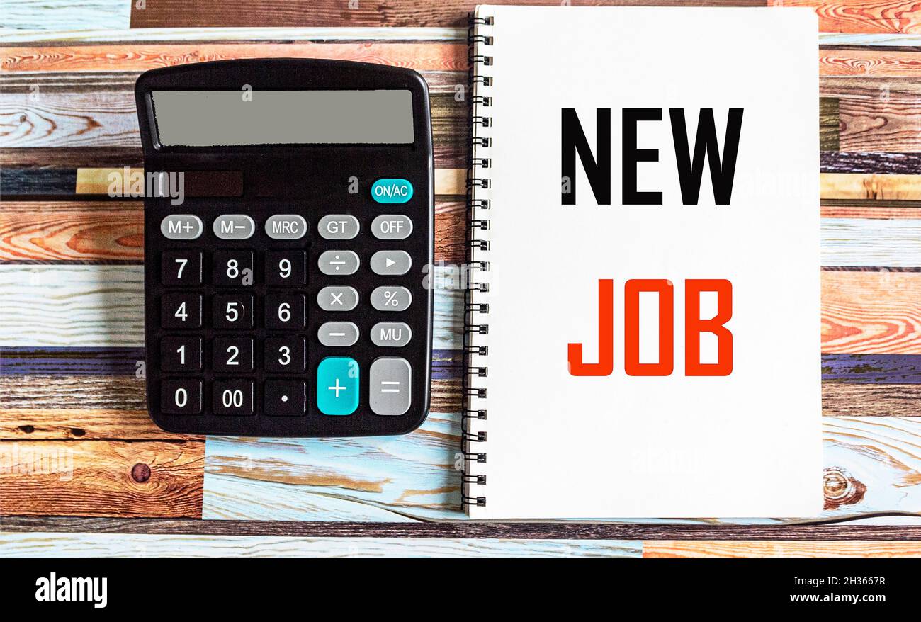 New Job, the text is written on a notepad with a calculator on a ...