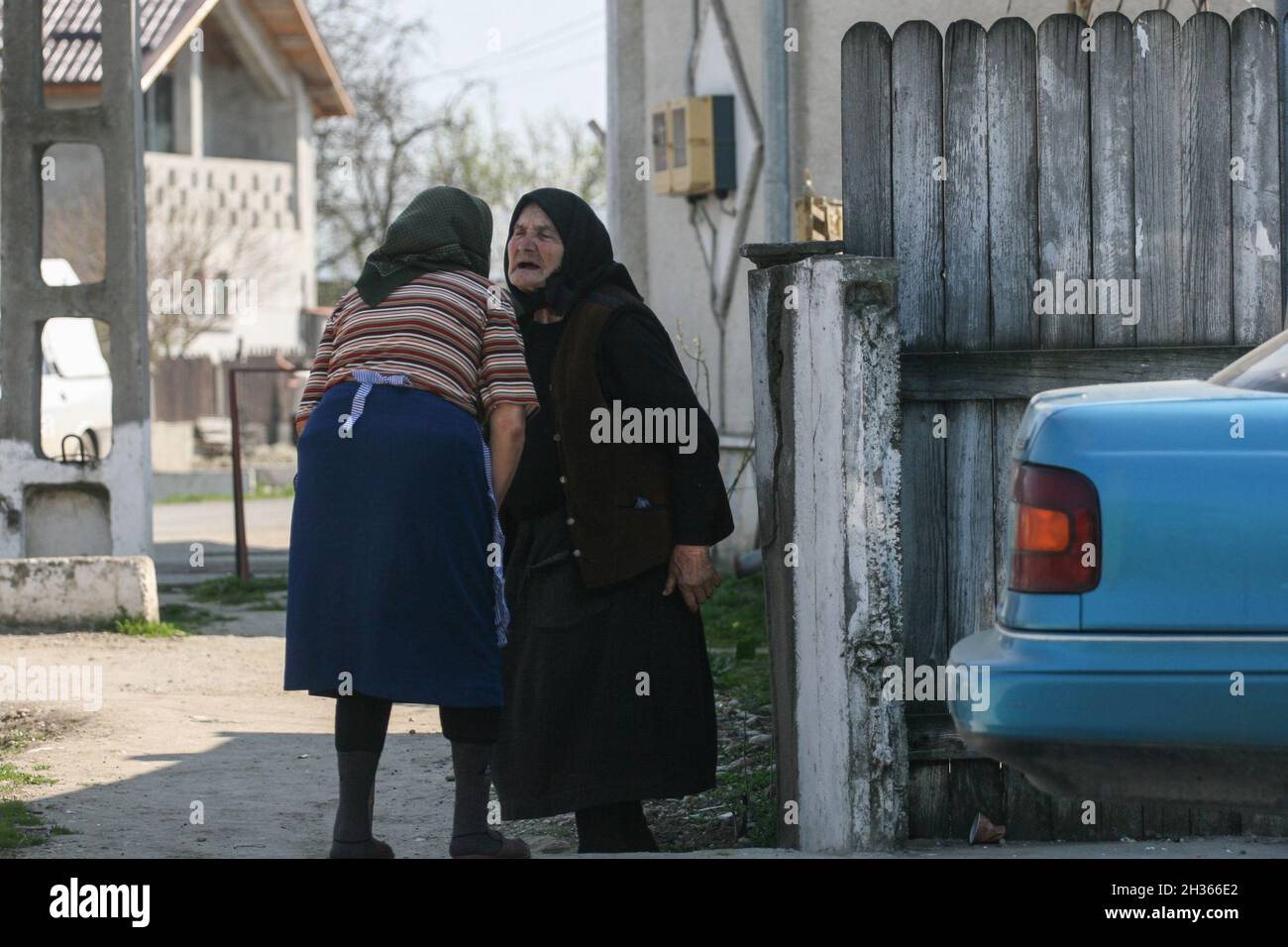 Varasti, Romania, April 5, 2009: Two old women are chatting on a street ...