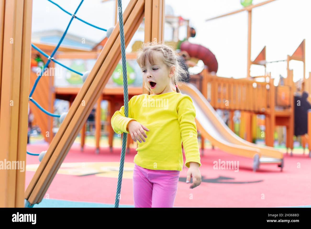 cute kid girl playing and climbing on the playground Stock Photo - Alamy