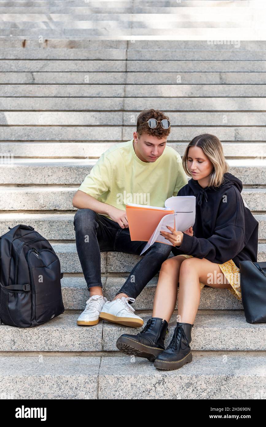 Two people sitting on stairs hi-res stock photography and images - Alamy