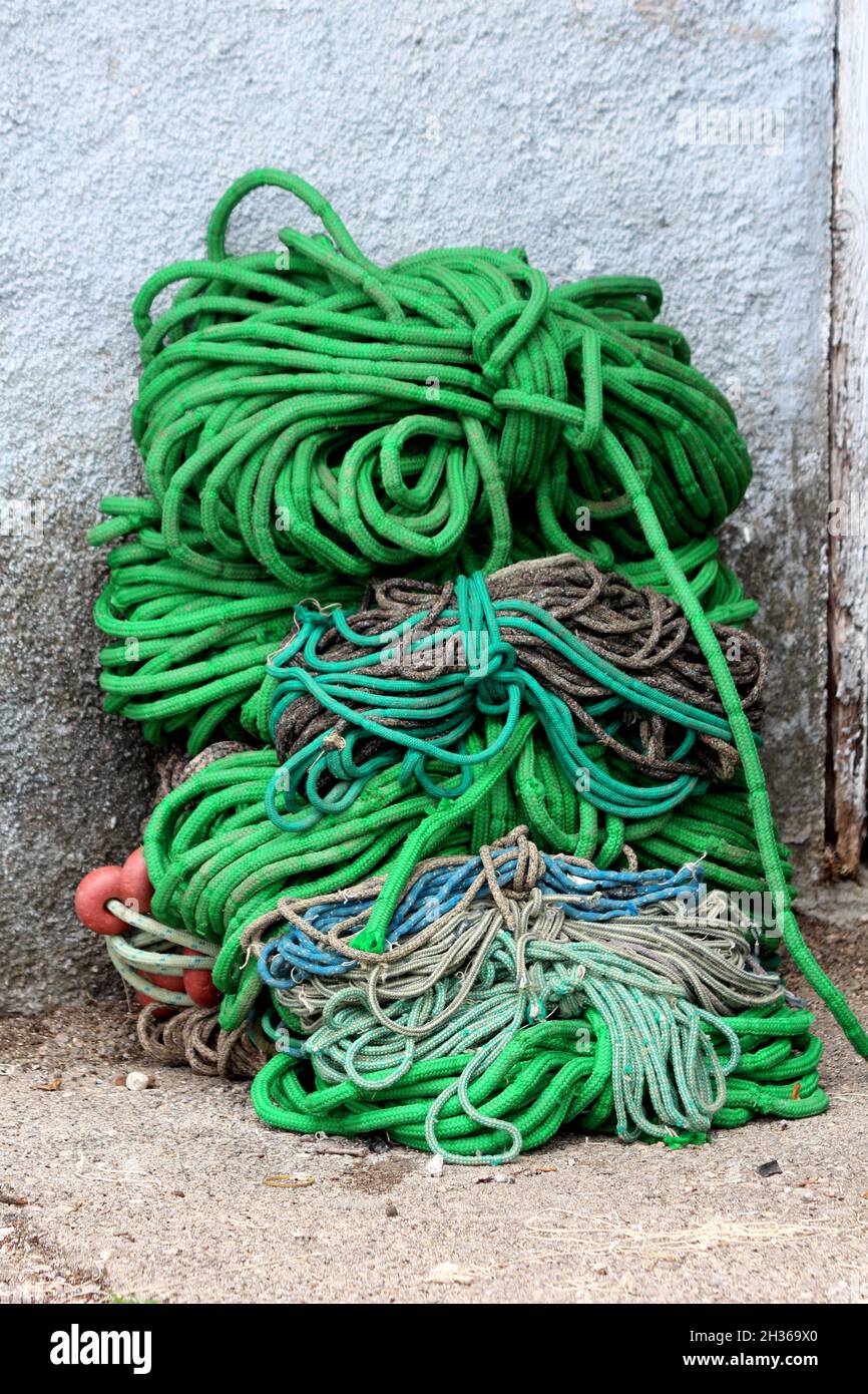 Large pile of multicolor heavily used thick old naval ropes mixed with ...