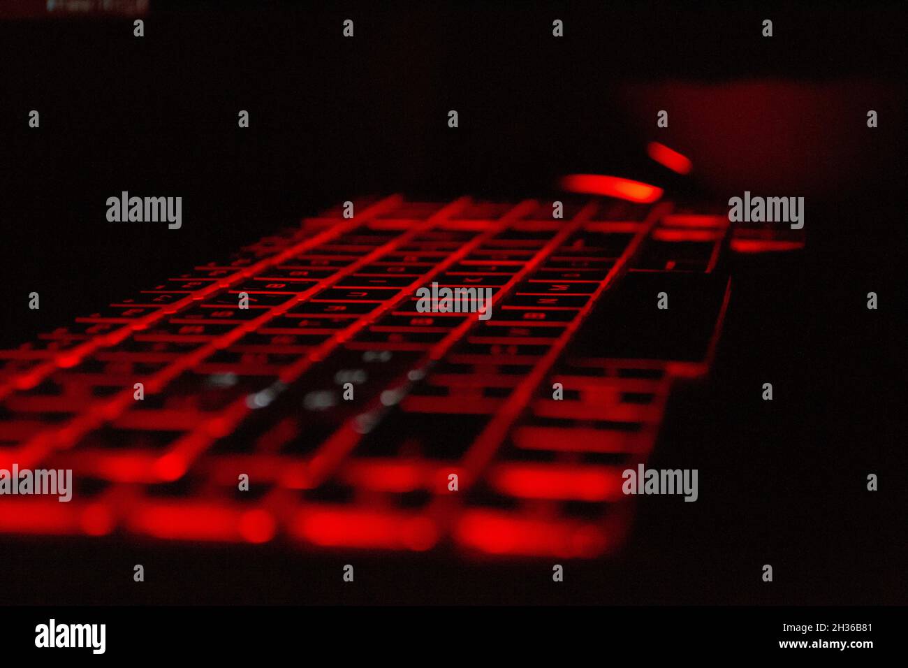 Hacker typing on keyboard red hi-res stock photography and images - Alamy