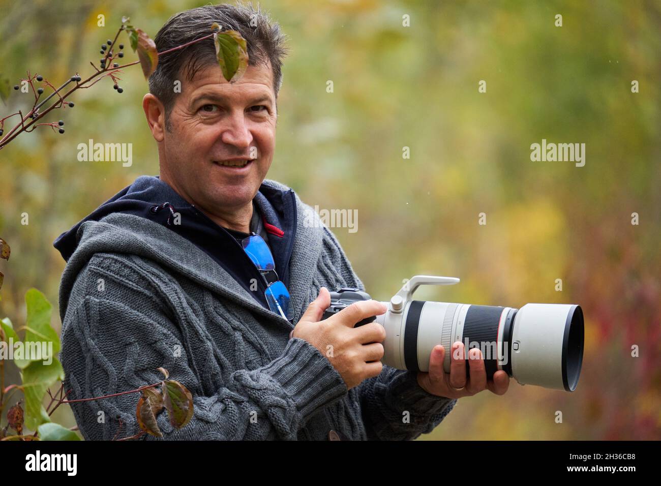 Professional wildlife photographer outdoor in the bush, shooting with a ...