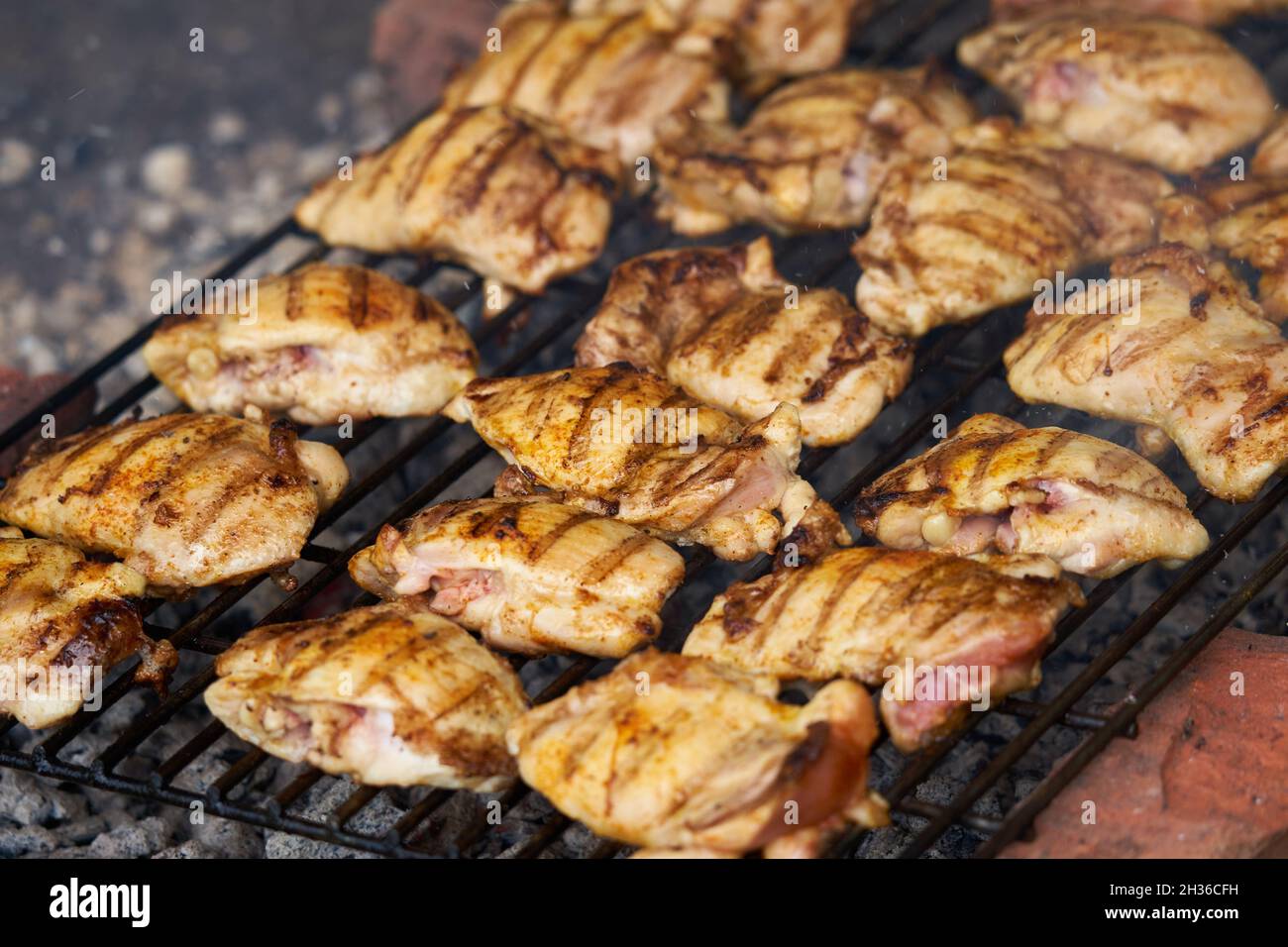 Chicken thighs grilled on hot embers outdoor Stock Photo - Alamy