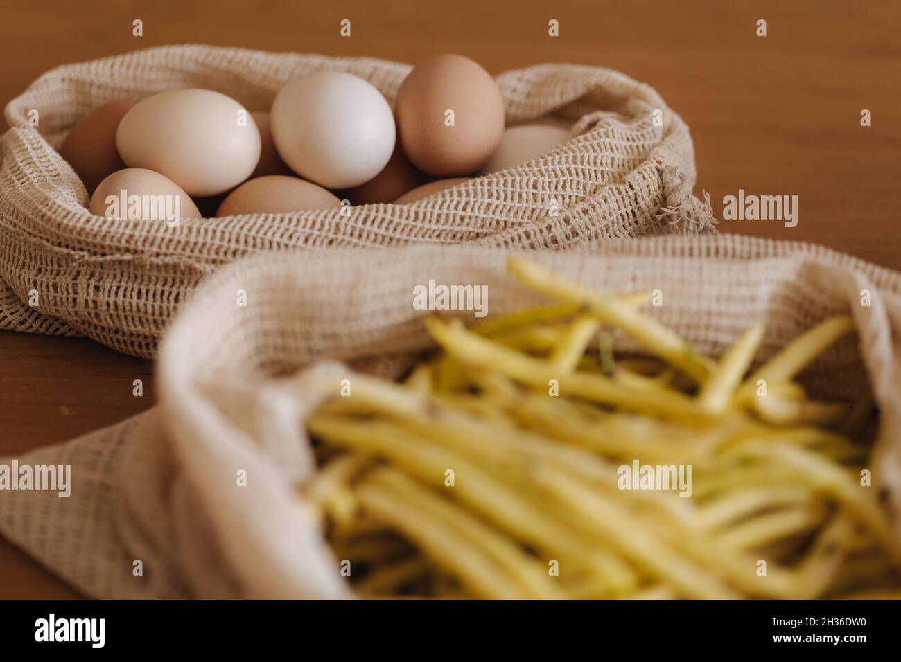 Eggs in canvas grocery bag. Eggs from eco farm. Cotton bags on wooden ...