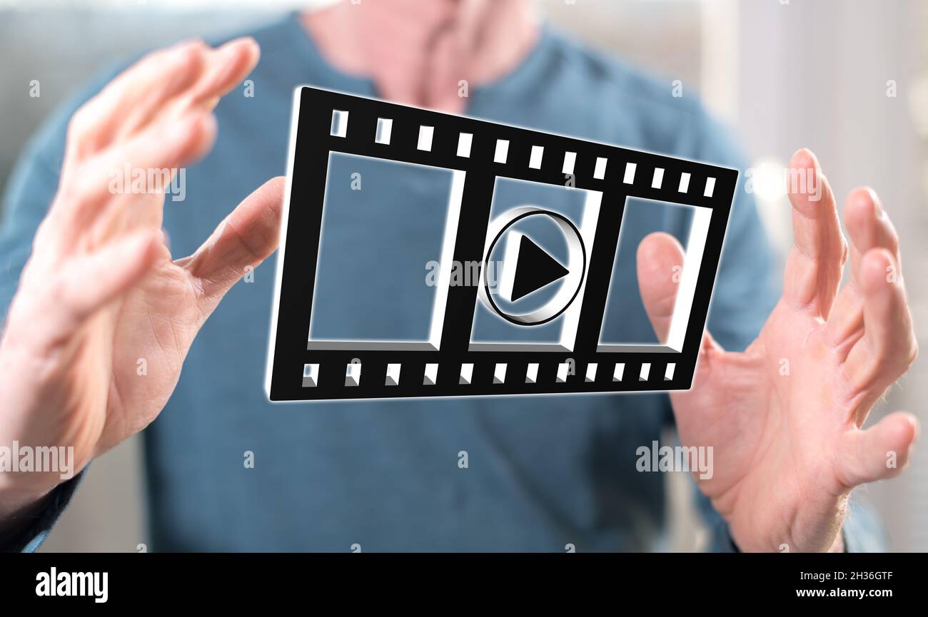 Movies, video and cinema concept between hands of a man in background ...