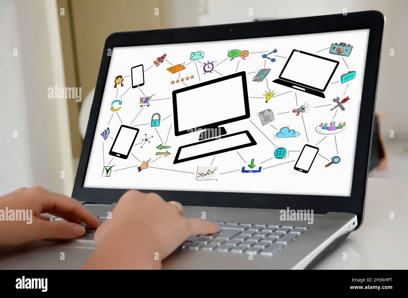 Hands on a laptop with screen showing network communication concept ...