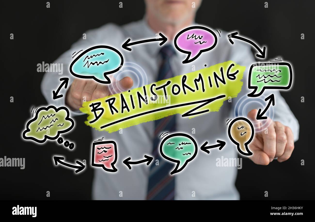 Man touching a brainstorming concept on a touch screen with his fingers ...