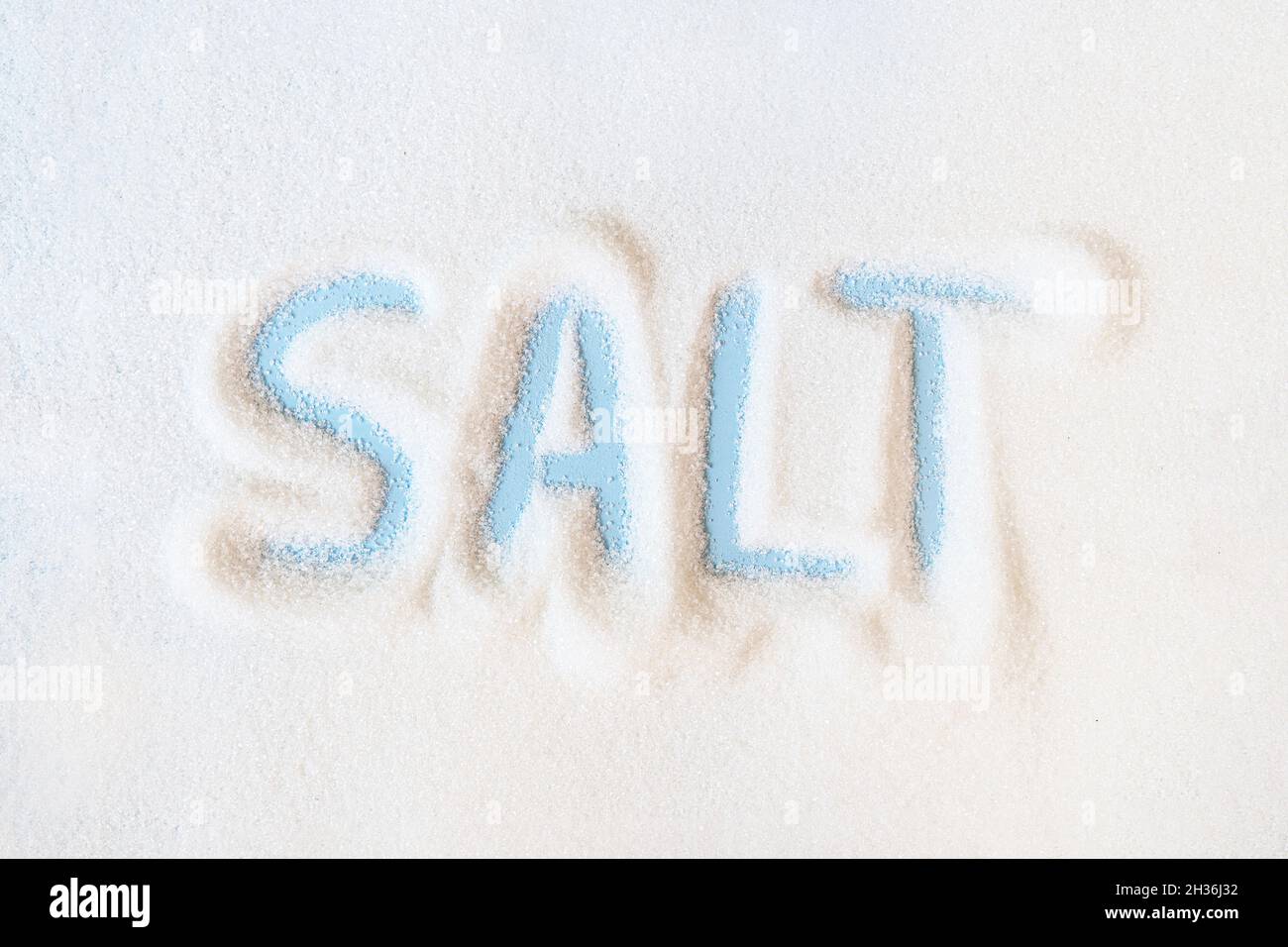 The blue word Salt on a background of scattered salt crystals Stock ...