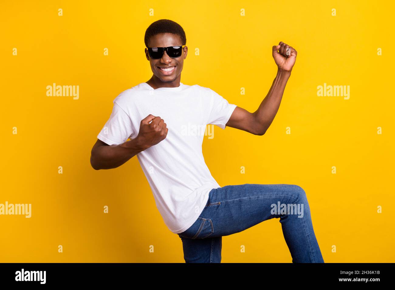 Portrait of attractive lucky cheerful guy dancing having fun rejoicing ...