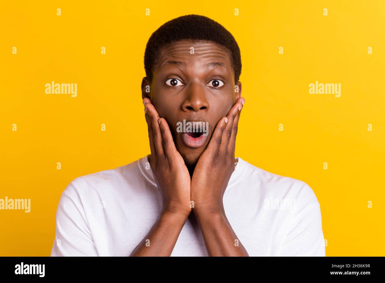 Photo of amazed shocked afro american young man hold hands cheeks ...