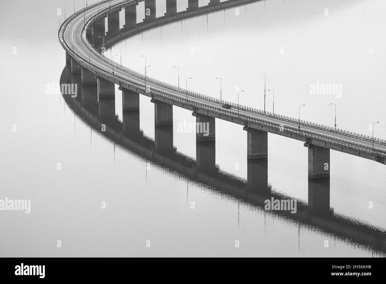 Aerial shot of a bridge and its reflection in grayscale Stock Photo - Alamy