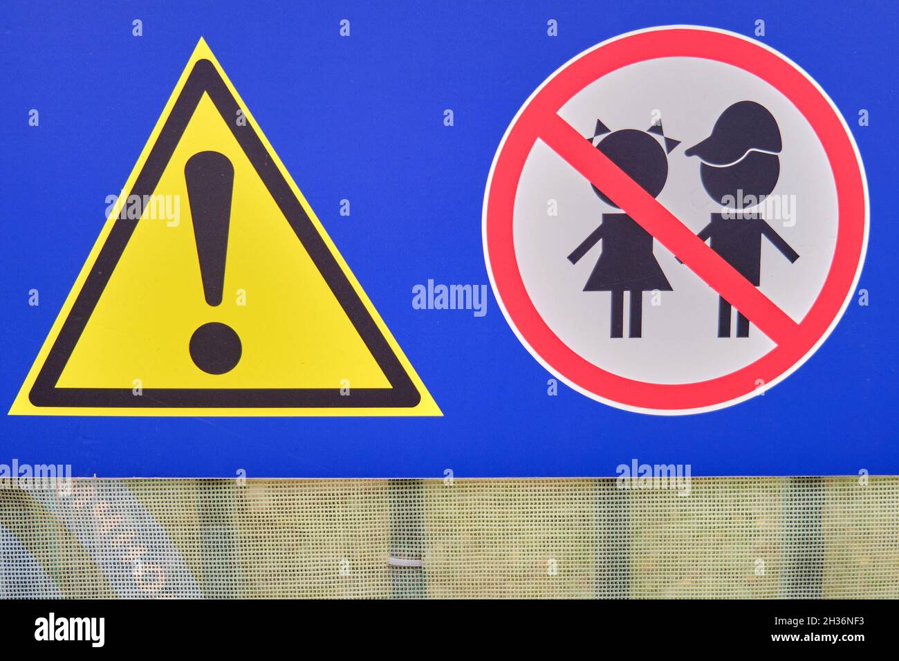 A sign prohibiting the entry of children on the fence near the ...