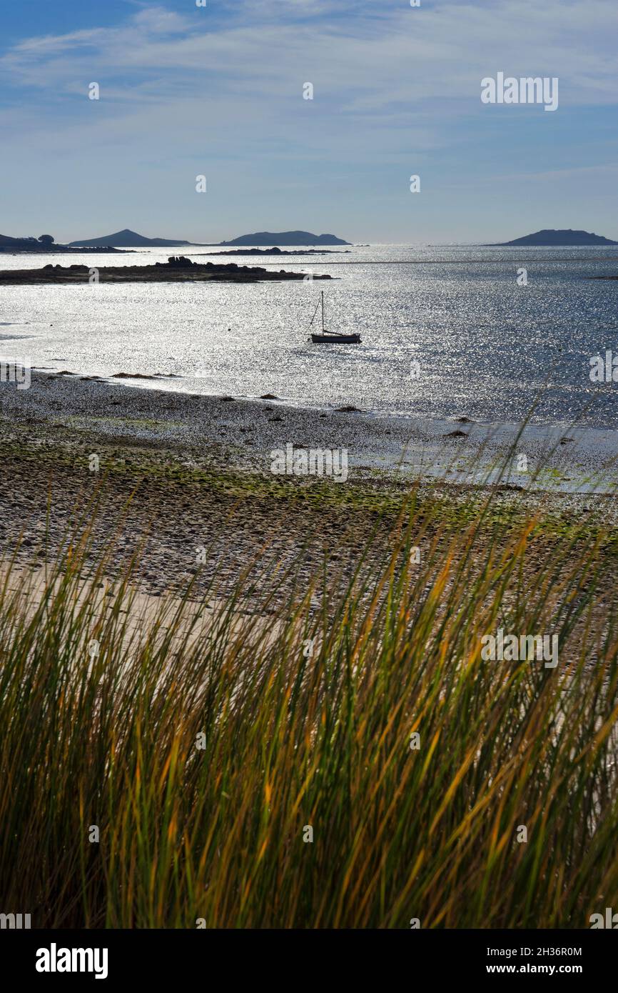 Sand dunes, beach and boat looking towards eastern Isles on St Martins ...