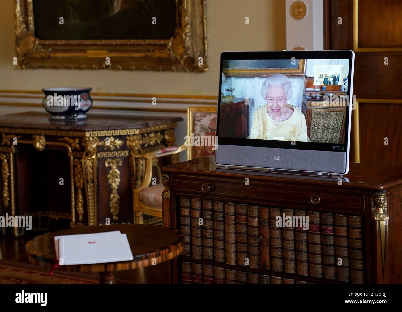 Queen Elizabeth II appears on a screen via videolink from Windsor ...