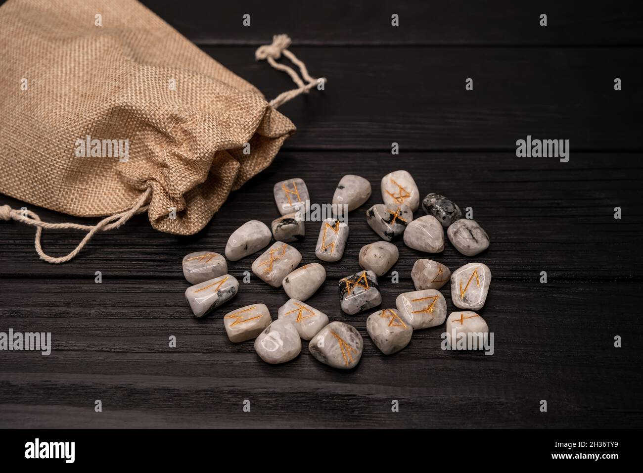 Stack of runes on gray desk. Magic symbols for esoteric divination ...