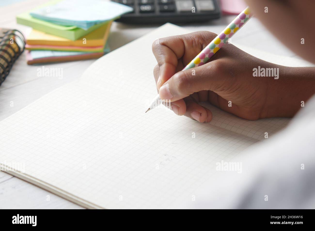 child girl hand writing on notepad Stock Photo - Alamy