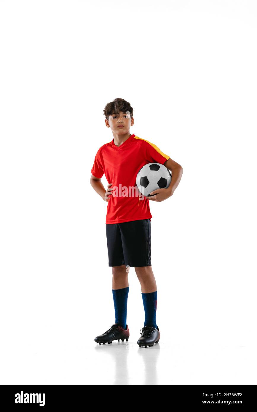 Full-length portrait of young boy, teenager, professional football ...