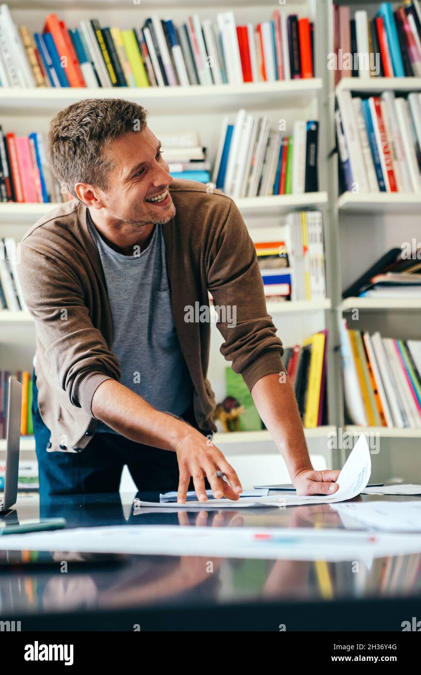 Portrait of happy successful smiling businessman working in office ...