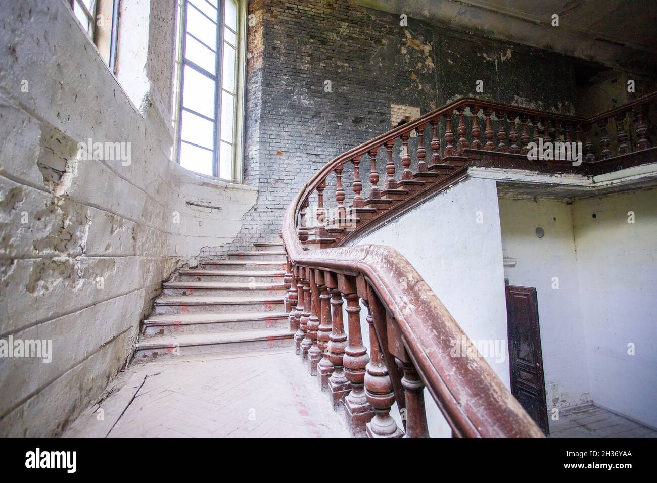 Bottom view of the wooden staircase in an old castle in light colors ...