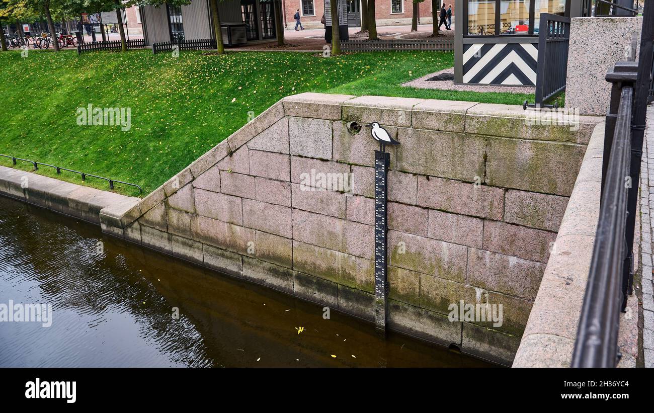 Stone pillar and water level meter on the river, horizonal orientation ...