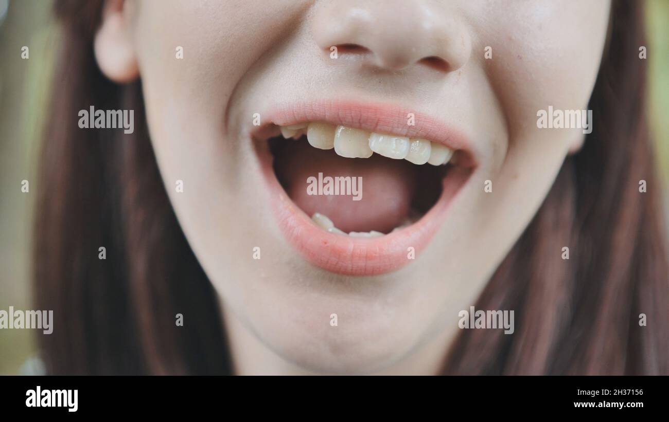 The young girl opens her mouth and shows her tongue. Stamatology theme ... The young girl opens her mouth and shows her tongue. Stamatology theme ...