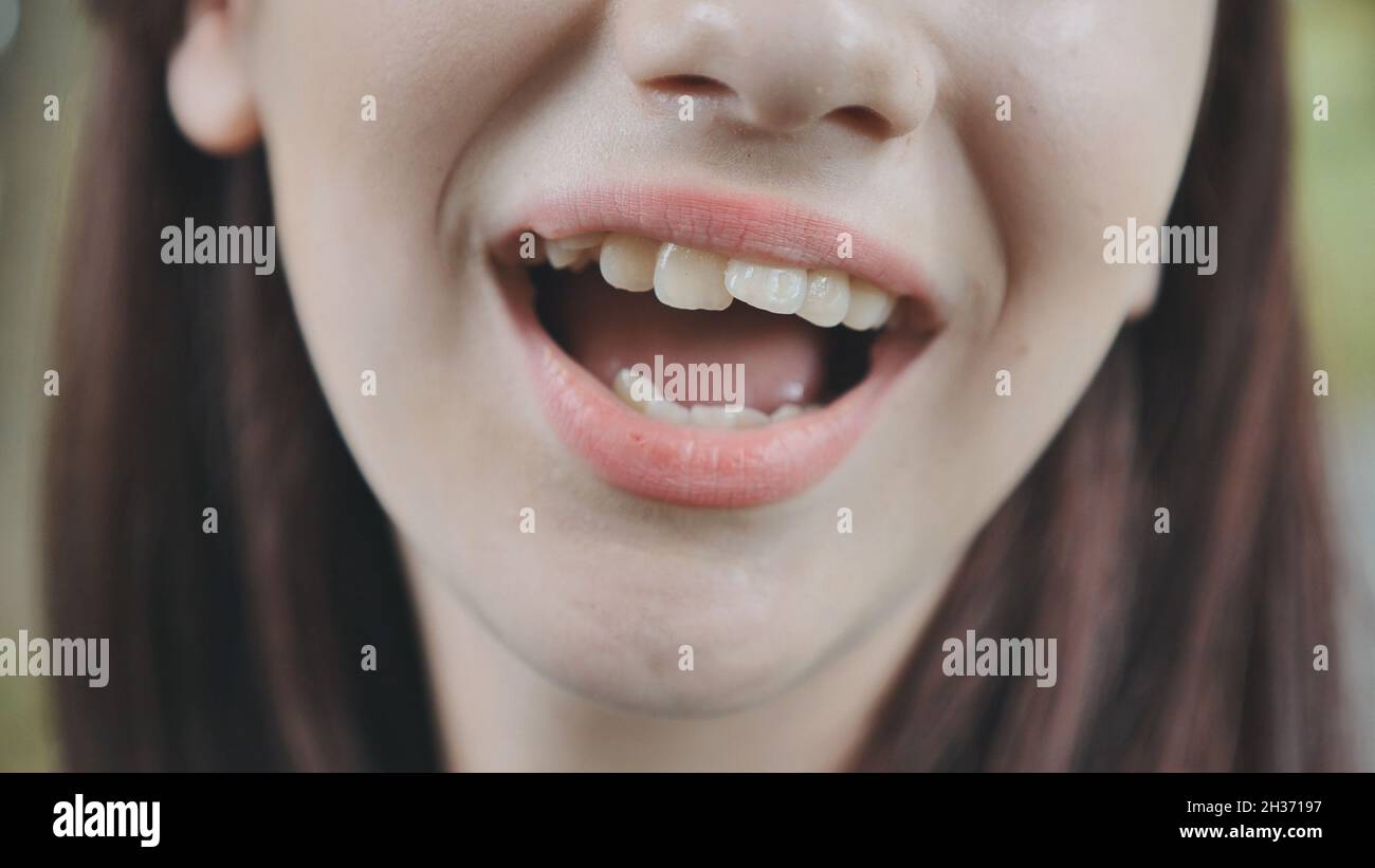 The young girl opens her mouth and shows her tongue. Stamatology theme ... The young girl opens her mouth and shows her tongue. Stamatology theme ...
