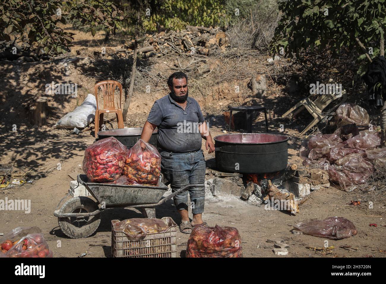 Al Alani, Syria. 24th Oct, 2021. A Syrian worker makes pomegranate ...