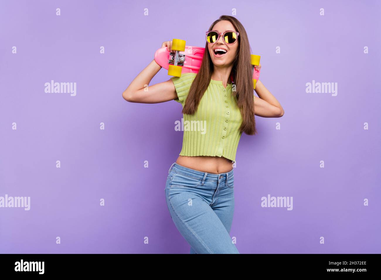 Portrait of attractive cheerful girl holding skate having fun good mood ...