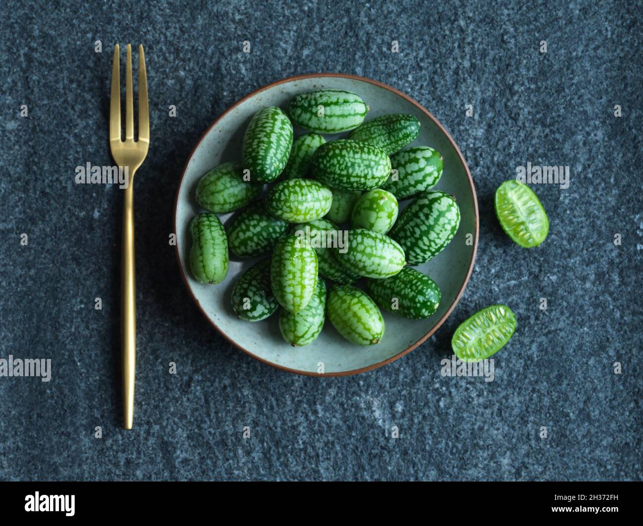 Finger water melon on plate with brass desert fork Stock Photo - Alamy