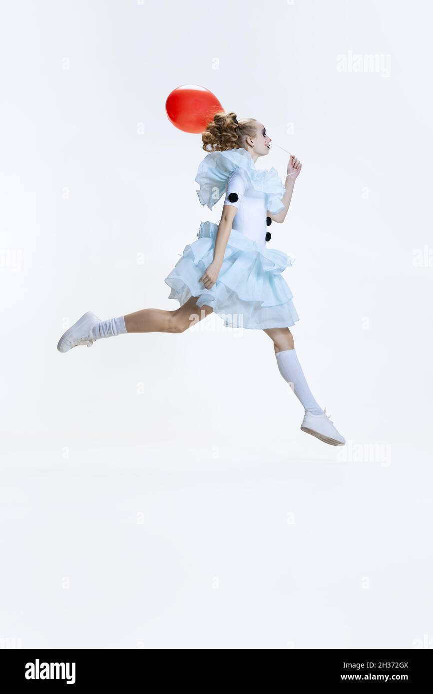 Full-length portrait of young girl wearing Halloween dress, costume of ...