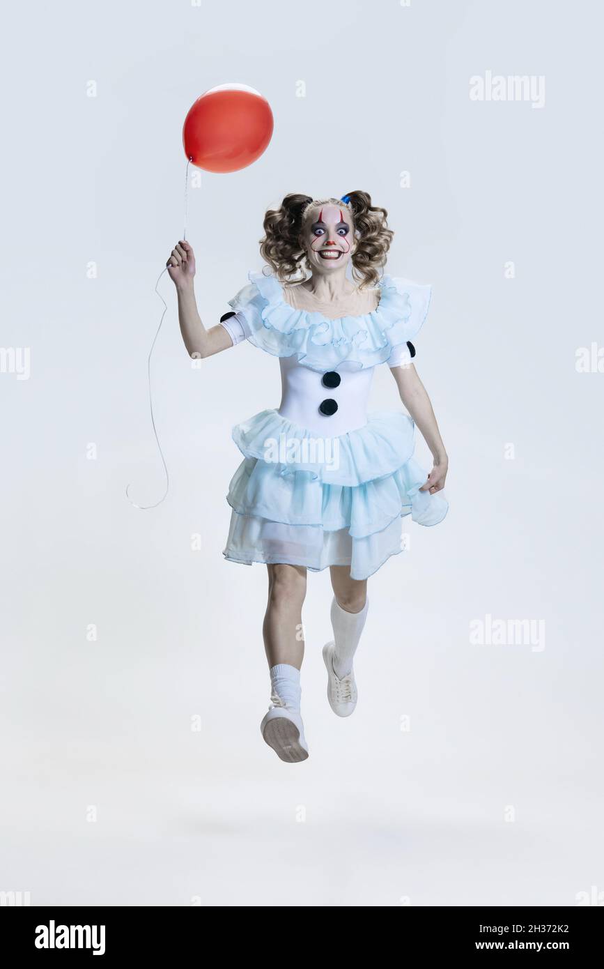 Full-length portrait of young girl wearing Halloween dress, costume of ...